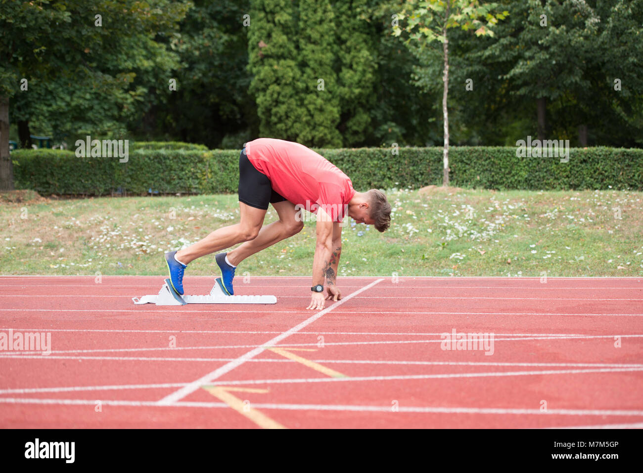 Sprinter Man Running on Red Tracks Lanes in Track and Field Stadium in ...