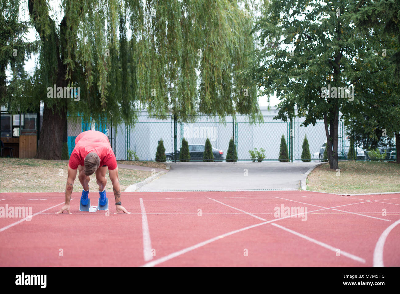 Man at running track in starting position hi-res stock photography and ...