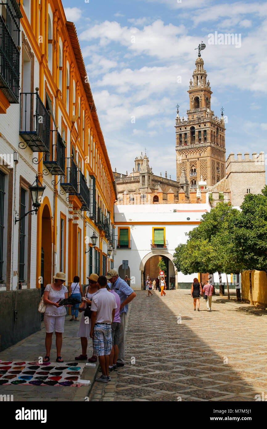 City view of Sevilla with tourists in the shadow and the Giralda ...
