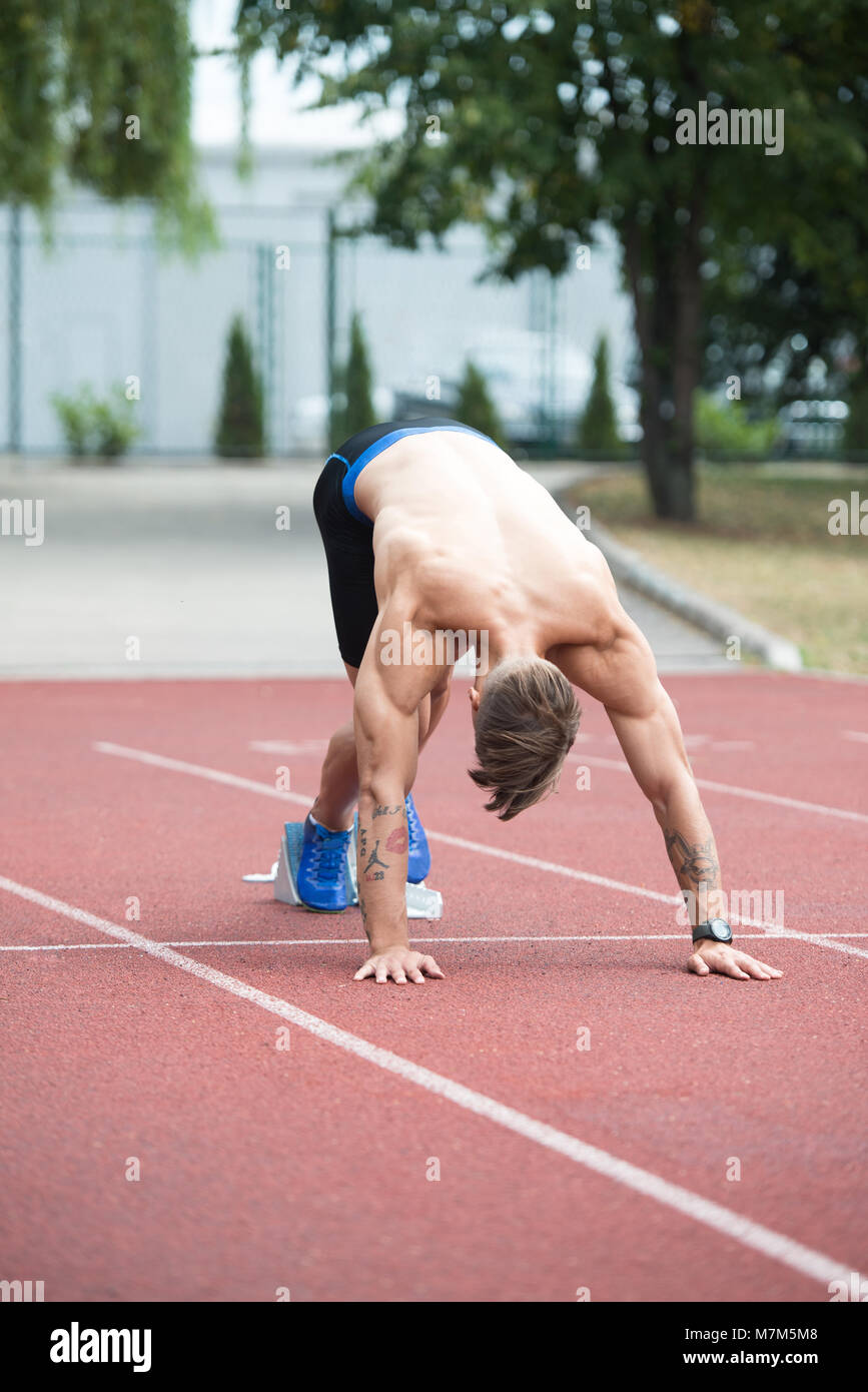 Sprinter Man Running on Red Tracks Lanes in Track and Field Stadium in ...