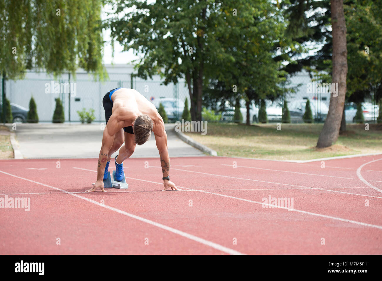 Man at running track in starting position hi-res stock photography and ...