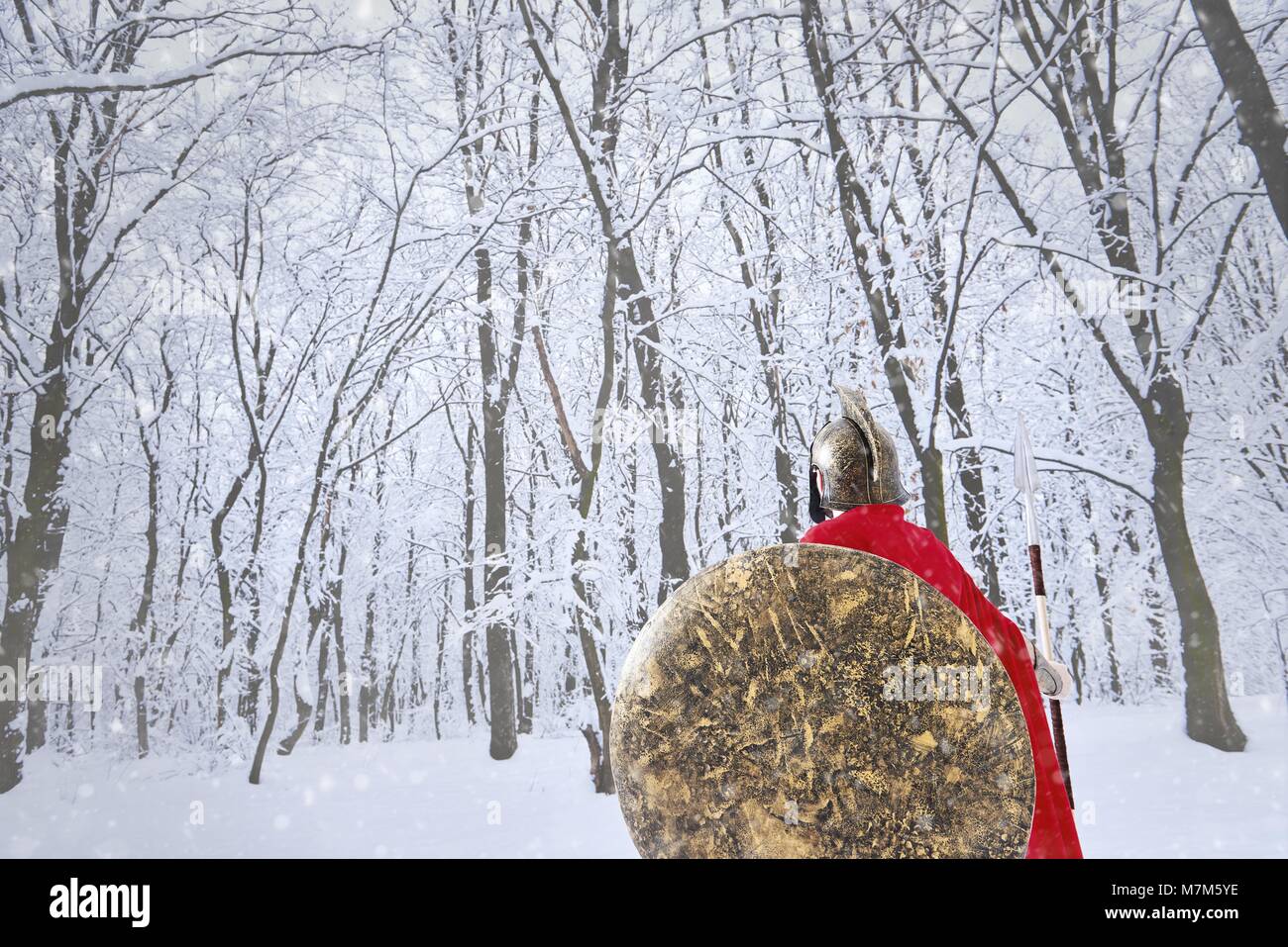 Spartan warrior is stealing in winter forest Stock Photo - Alamy