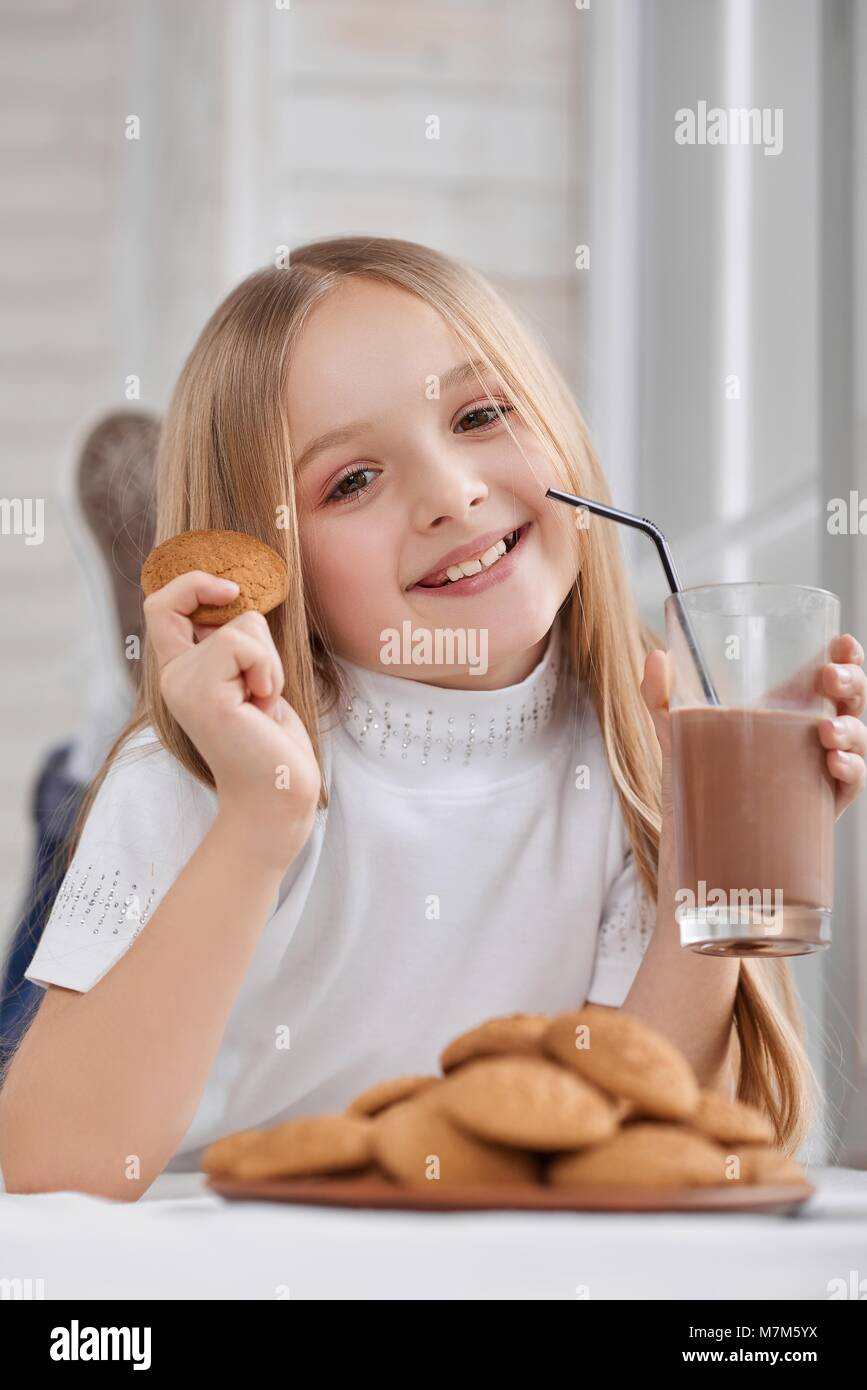 Little girl with cookies and chocolate milk Stock Photo - Alamy