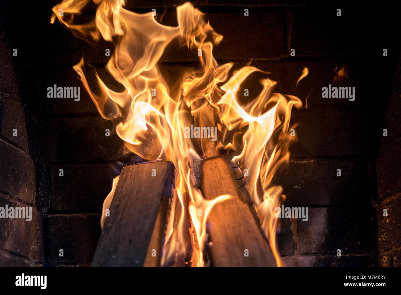 Frozen bright fire in the fireplace. Bright fire in the fireplace close ...