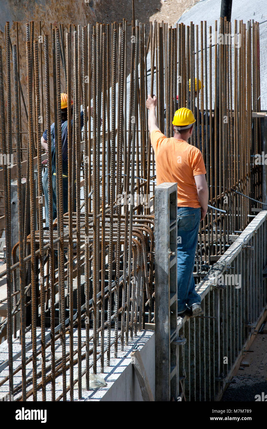 Construction workers between steel bars Stock Photo - Alamy