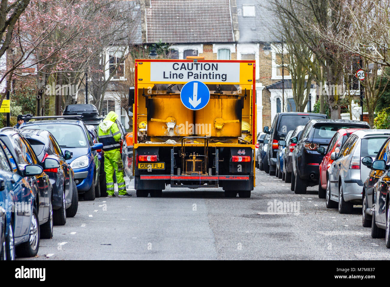 Lorry in a residential street in North London with operative repainting ...