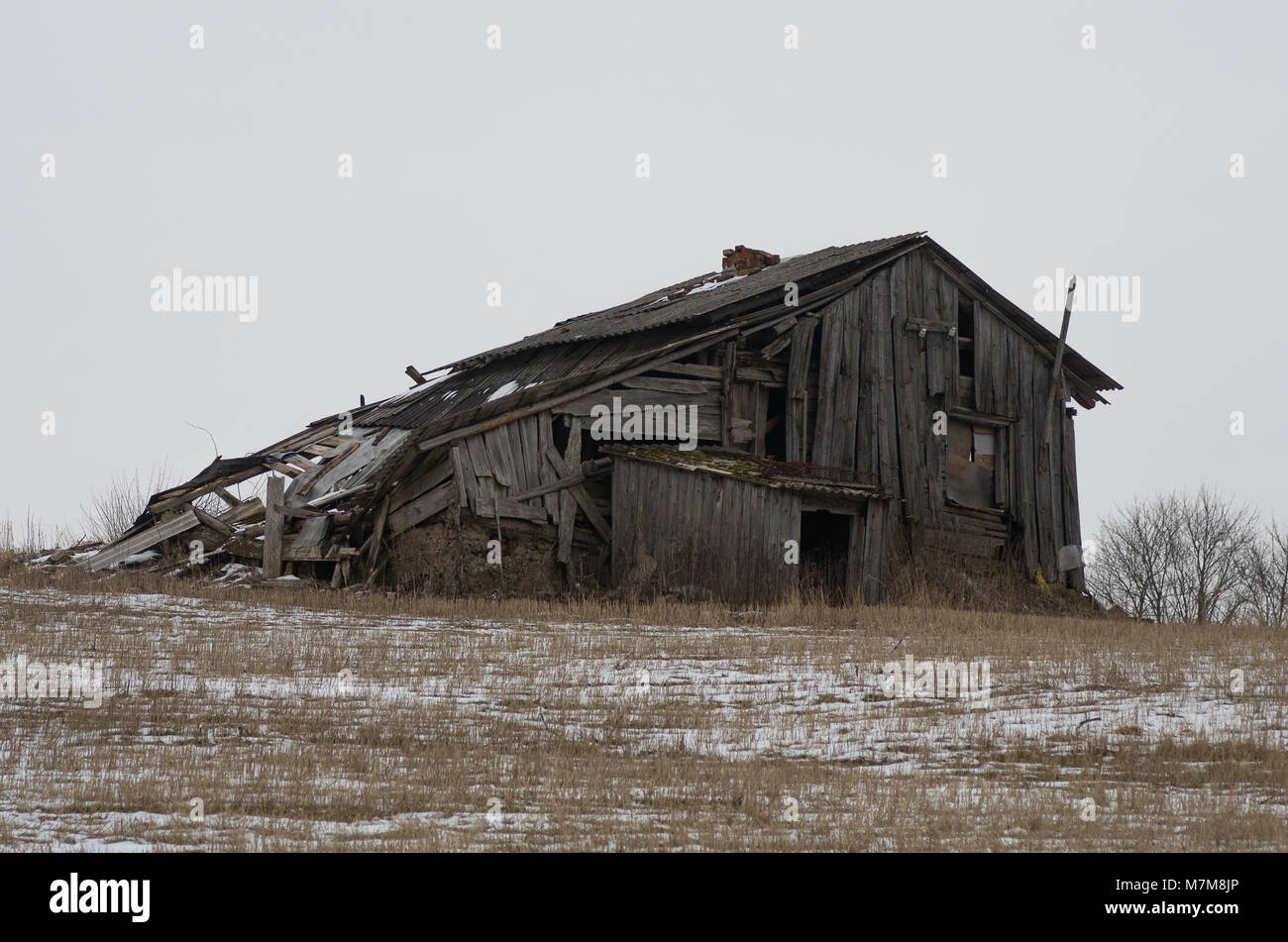 Ruins of an abandoned wooden cabin in the winter landscape Stock Photo ...