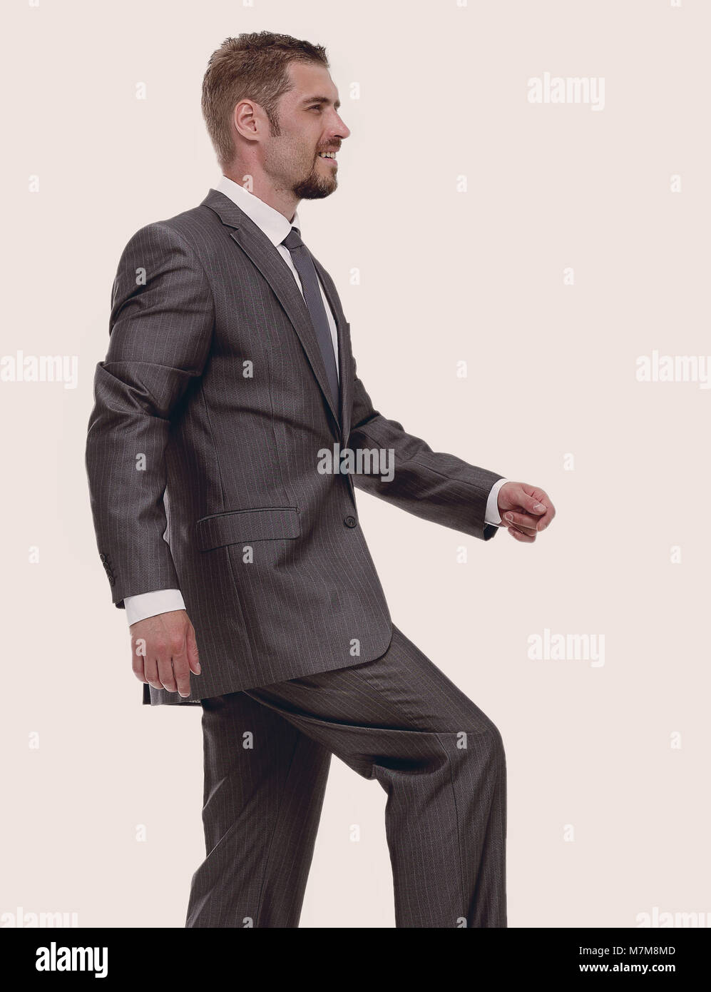 in full growth.side view.businessman stepping forward Stock Photo - Alamy