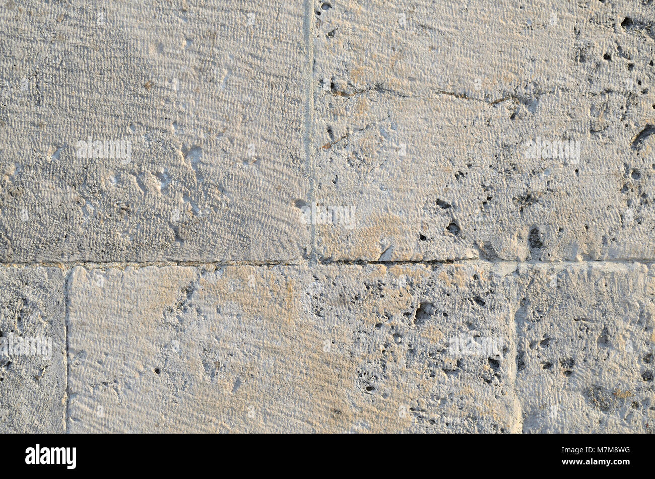 Beige and grey stone wall suitable as a background Stock Photo - Alamy
