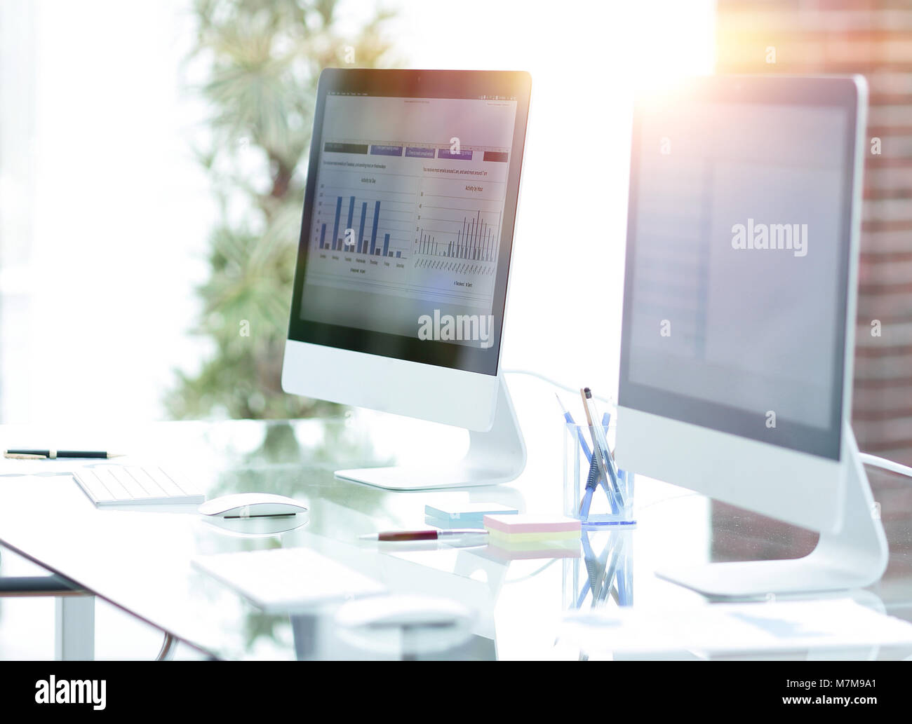close-up of the screens of personal computers on a modern workplace in ...