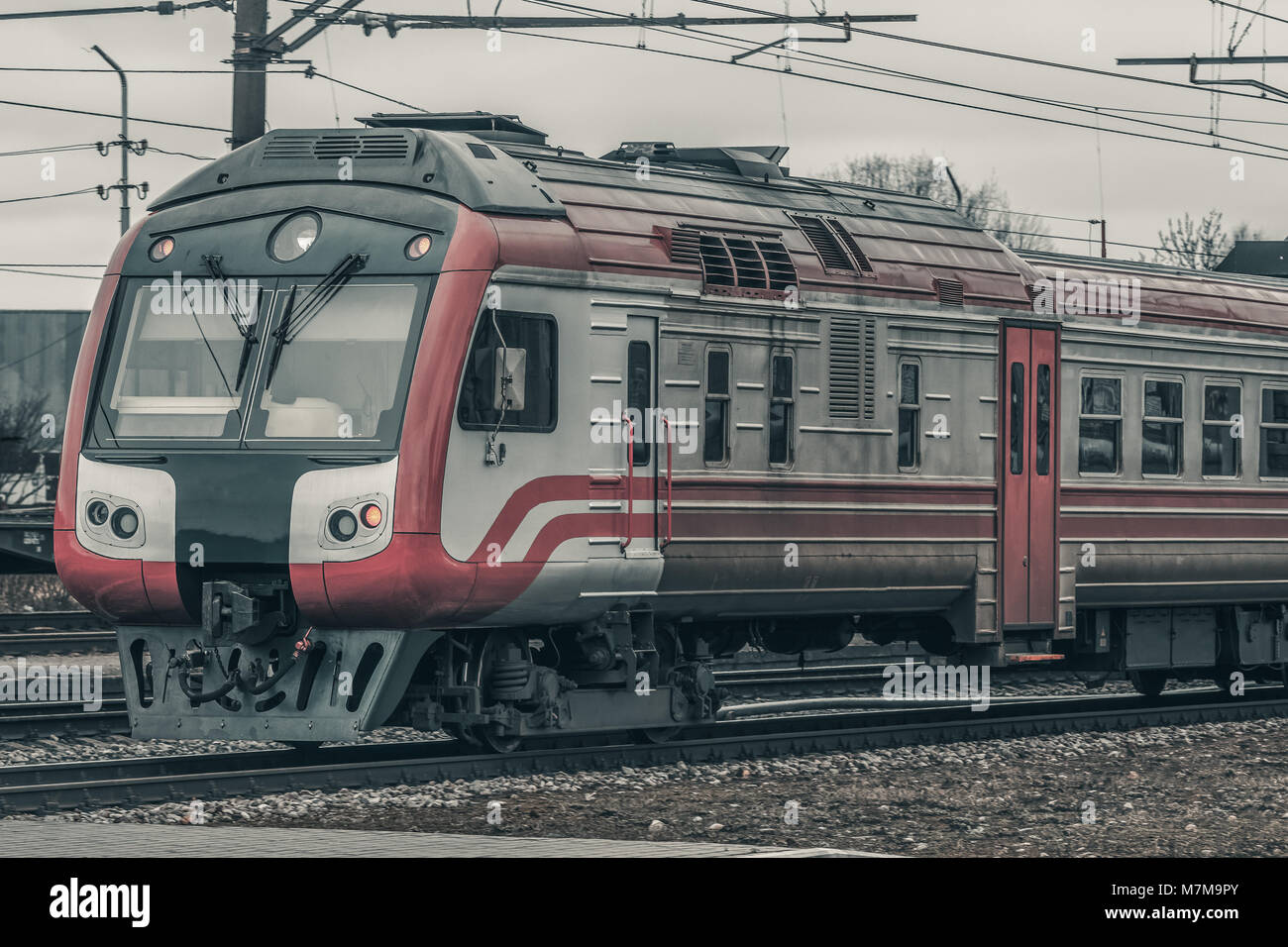 Red diesel passenger train driving at the old terminal Stock Photo - Alamy