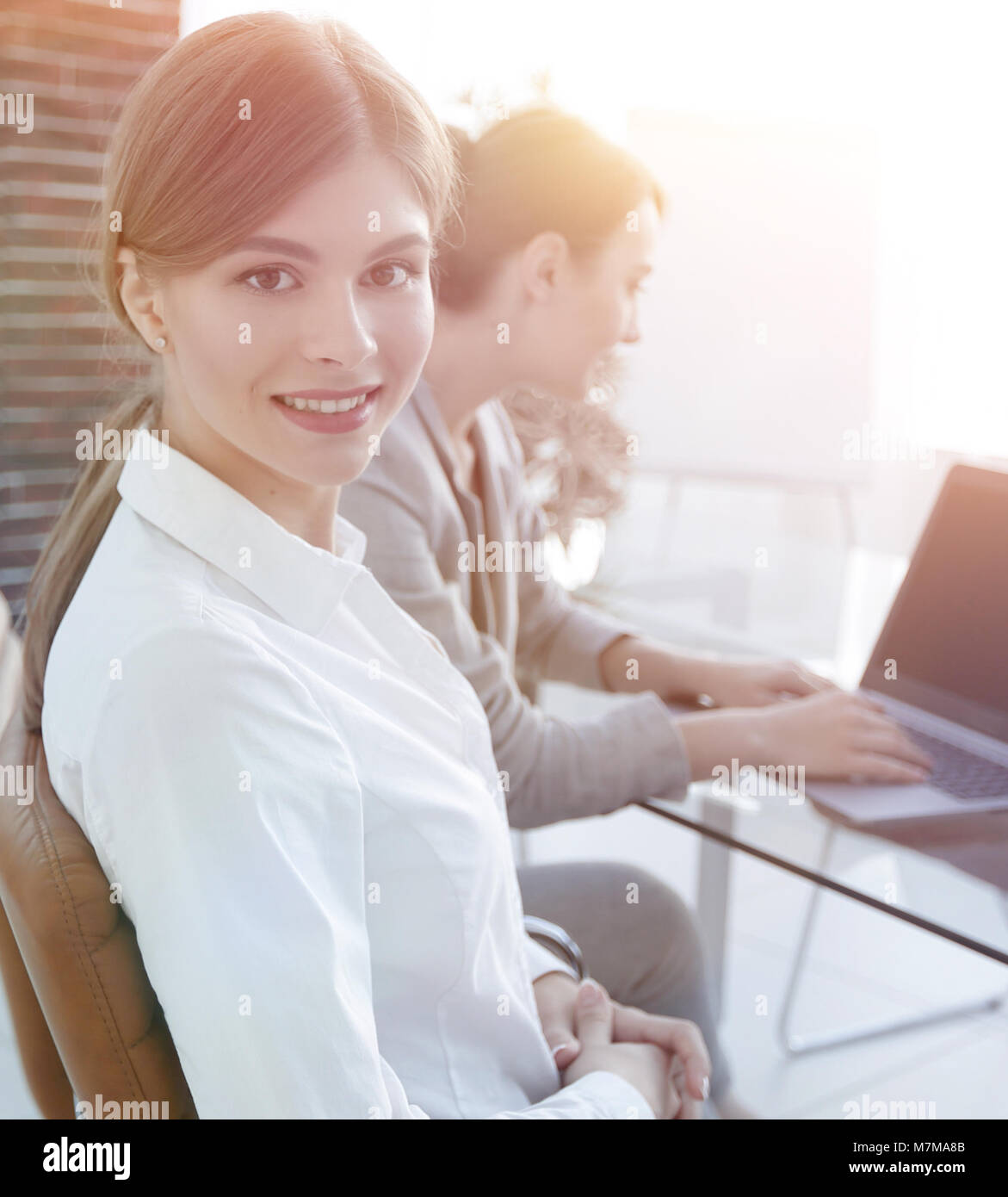 office workers sitting behind a Desk Stock Photo - Alamy