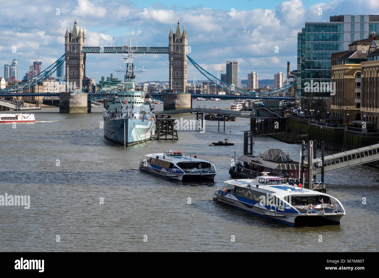 the view from london bridge towards HMS Belfast and tower bridge with ...