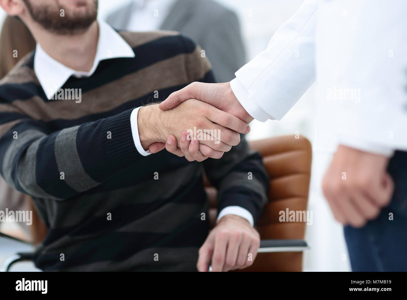 handshake between colleagues in the workplace Stock Photo - Alamy