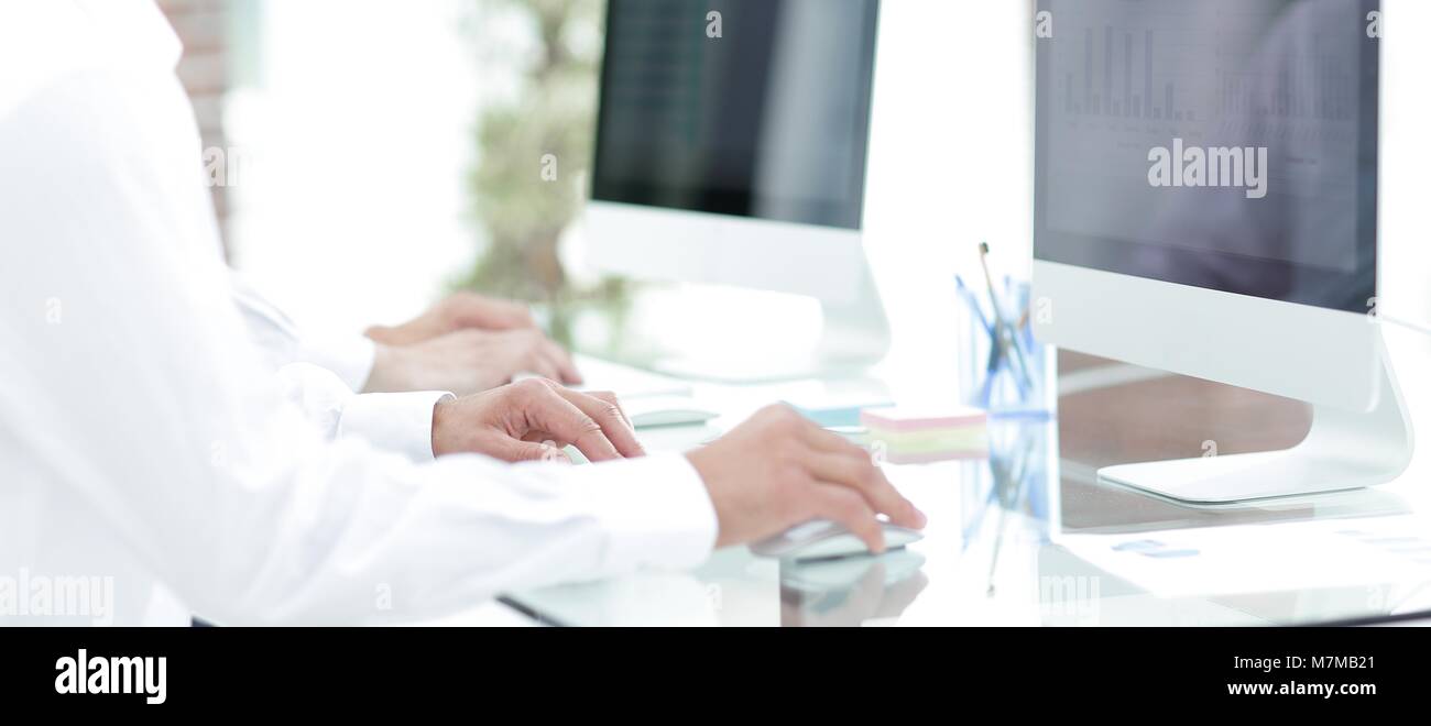 hands typing text on the computer keyboard. blurred business background ...