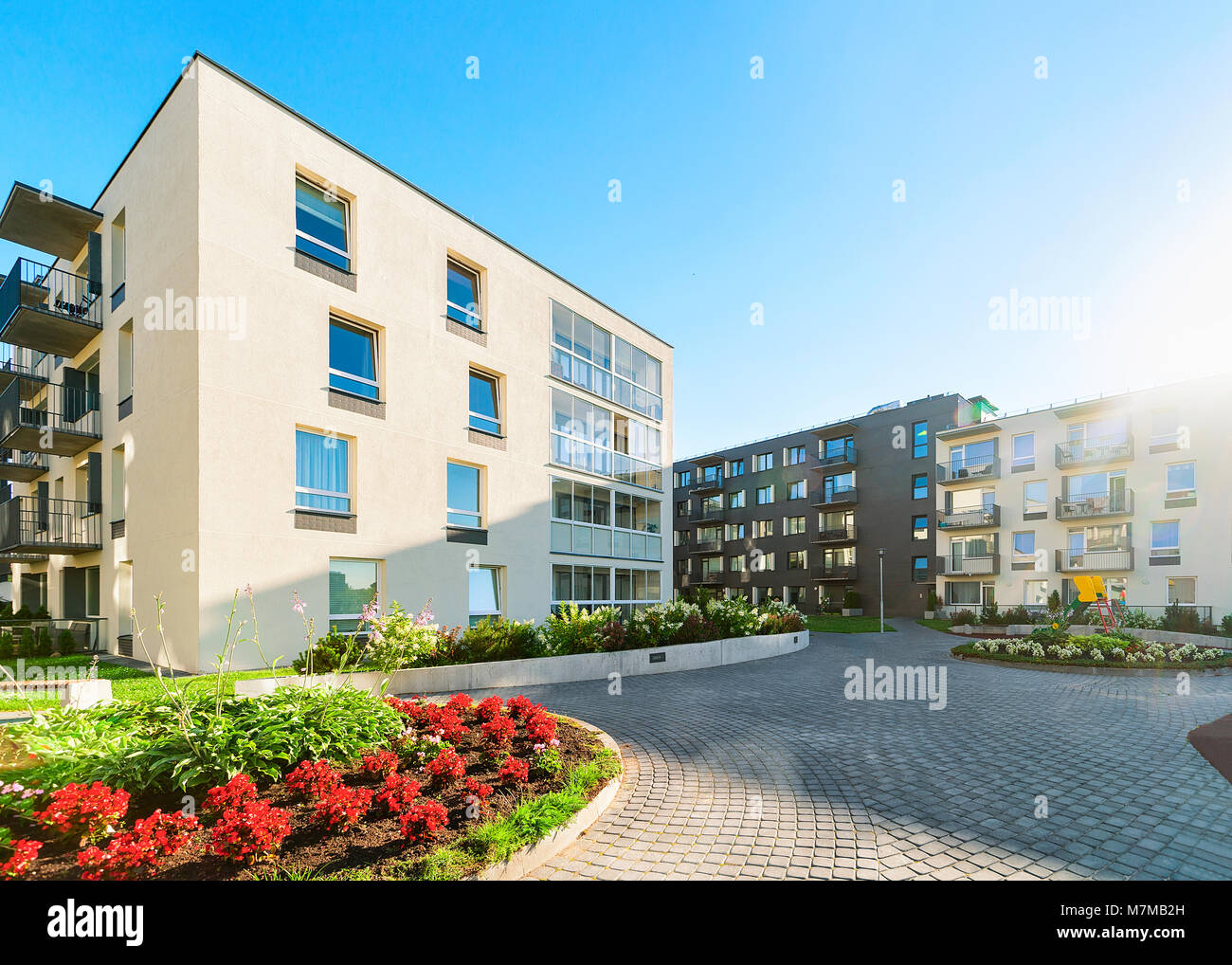 Complex of modern apartment residential buildings with flower plants ...