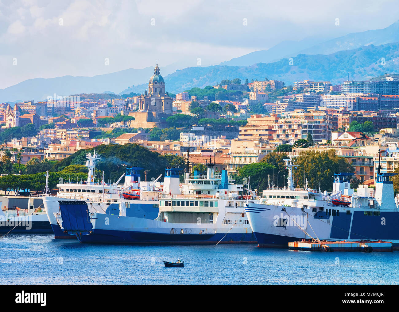 Passenger ferries in the Mediterranean Sea and cityscape of Messina ...