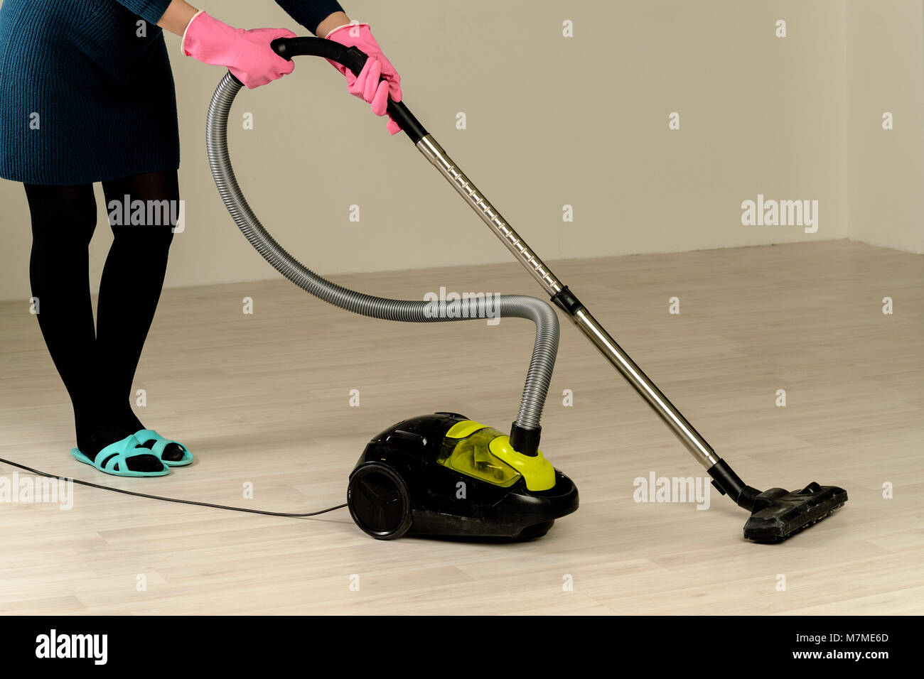 woman cleans the floor with vacuum cleaner Stock Photo - Alamy