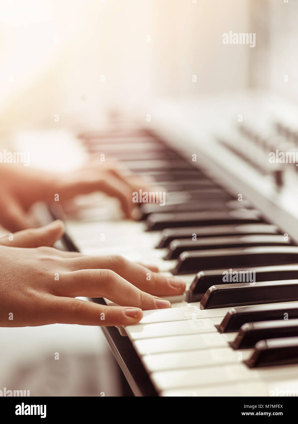 Midi keyboard or electronic piano and playing child hands Stock Photo ...