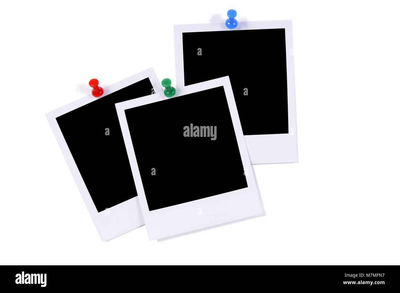 Blank photo prints pinned to a white paper background. Space for copy ...