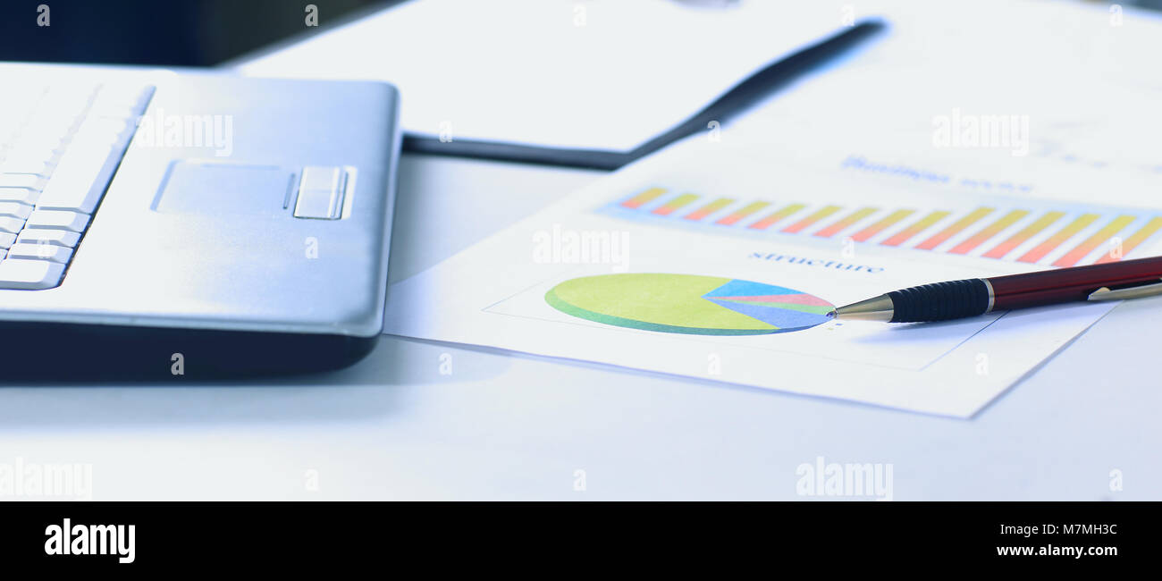 workplace with laptop and working documents for the business team in a ...