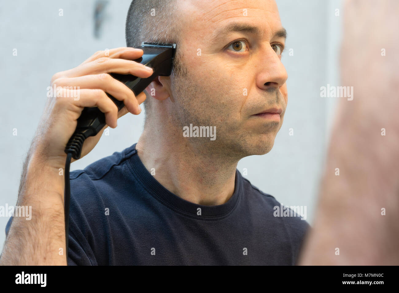 Young bald man shaving head hi-res stock photography and images - Alamy