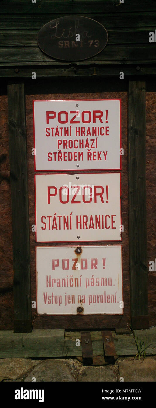 This image shows a detailed view of a boundary sign from a border area ...