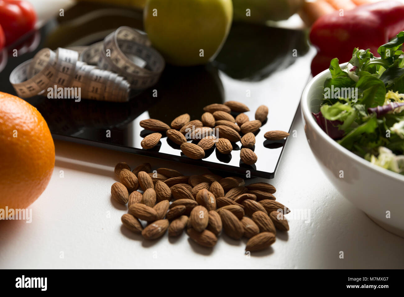 Healthy fruit,vegetables and nuts, scales and measuring tape. Weight ...