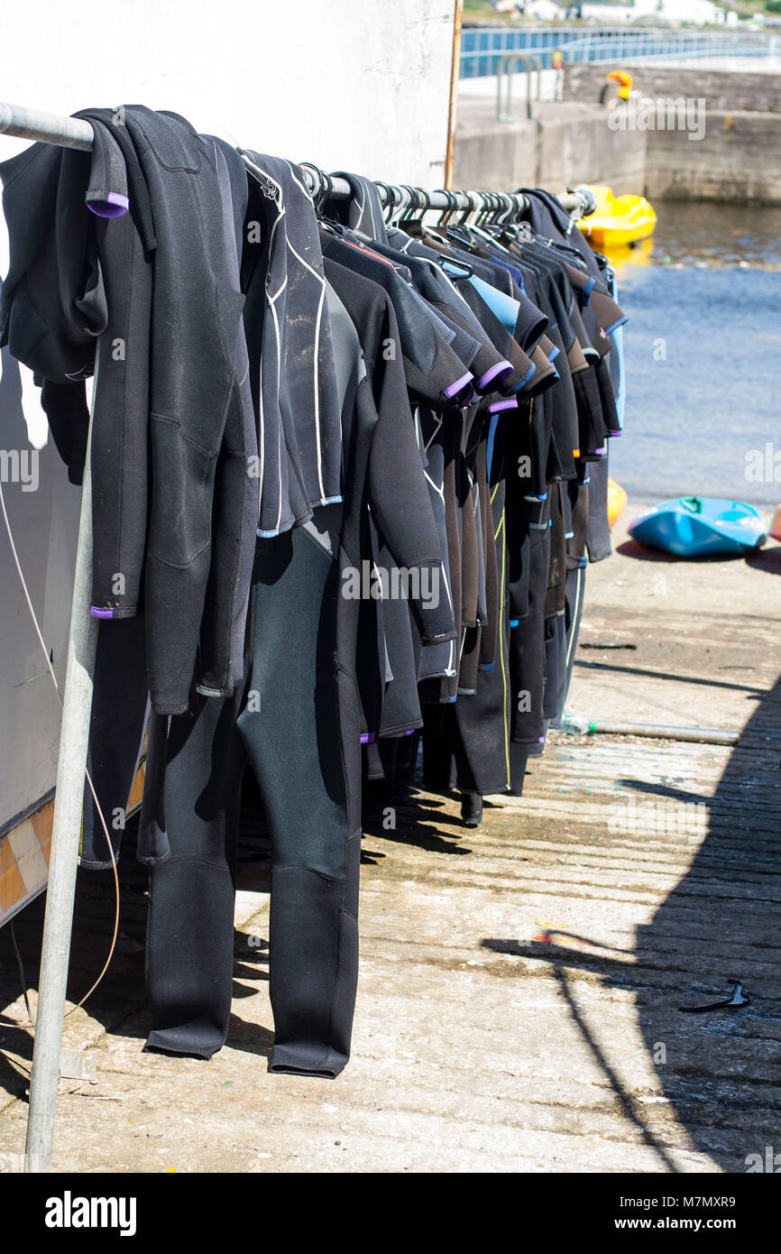 Wetsuits hanging on a rail hi-res stock photography and images - Alamy