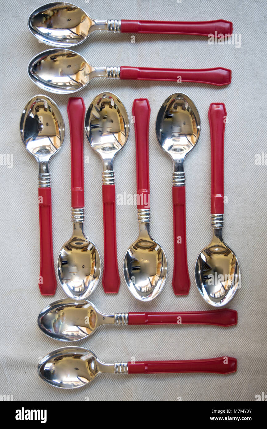 composition of silver dessert spoons with colored handle Stock Photo ...