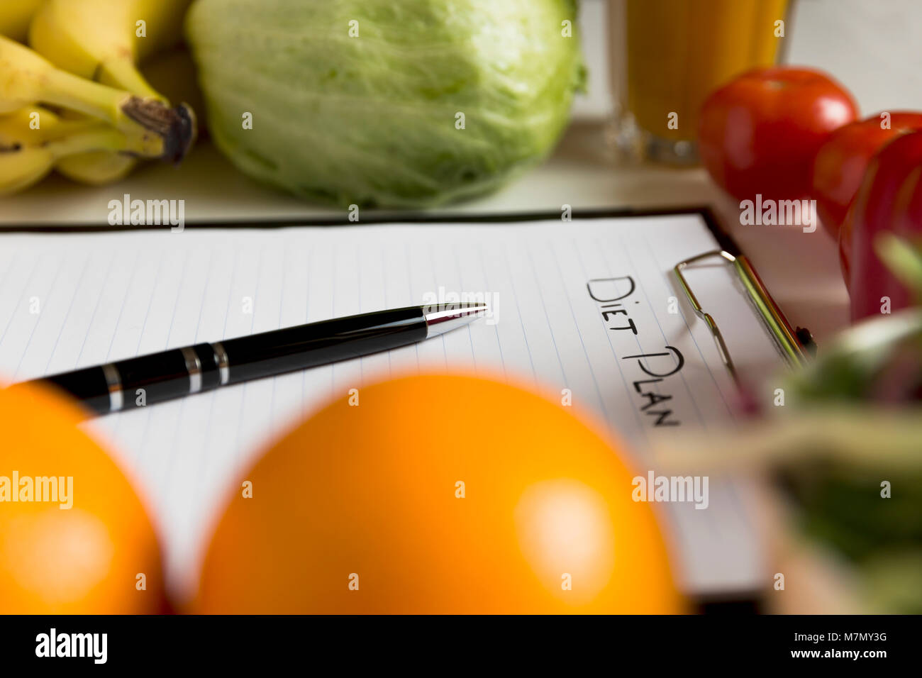 Sheet of Diet Plan and fresh products on wooden table Stock Photo - Alamy