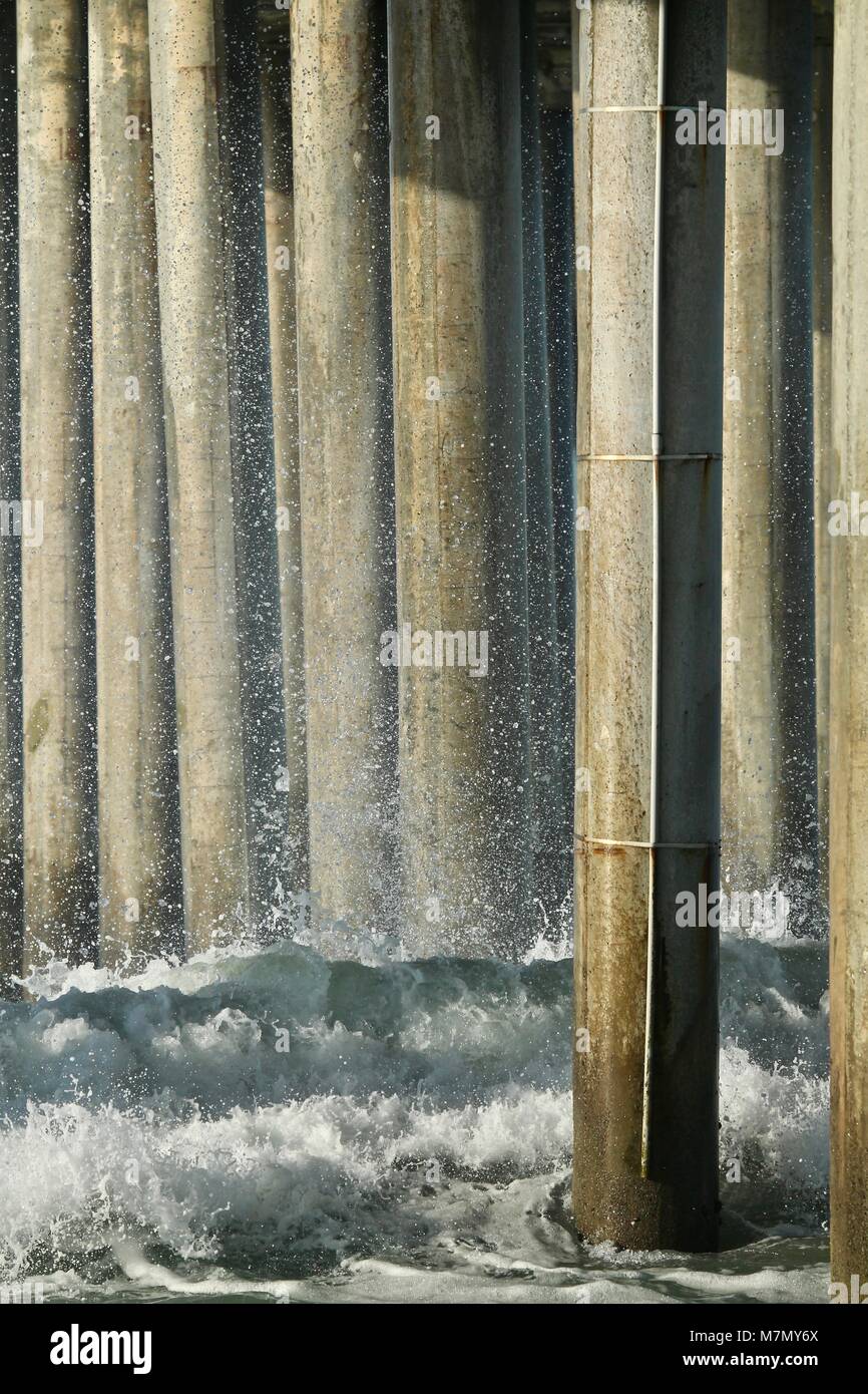 waves crashing on pier pilings Stock Photo - Alamy