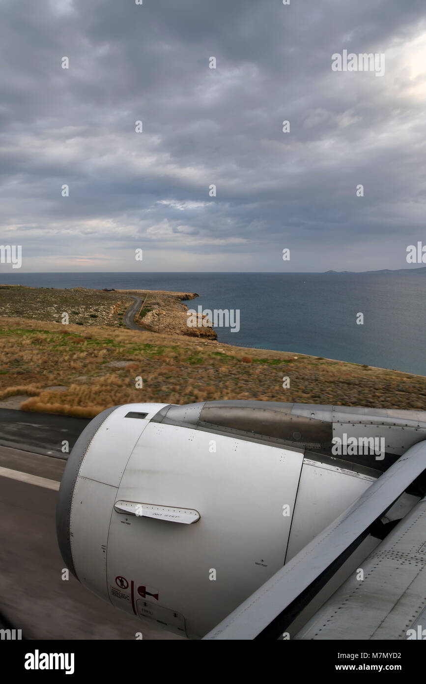 Looking through a window of an Airbus A320 during landing in Iraklion ...