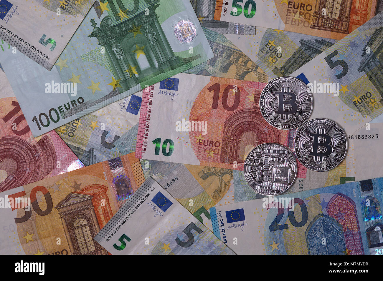 Silver bit coin on euro money background Stock Photo - Alamy