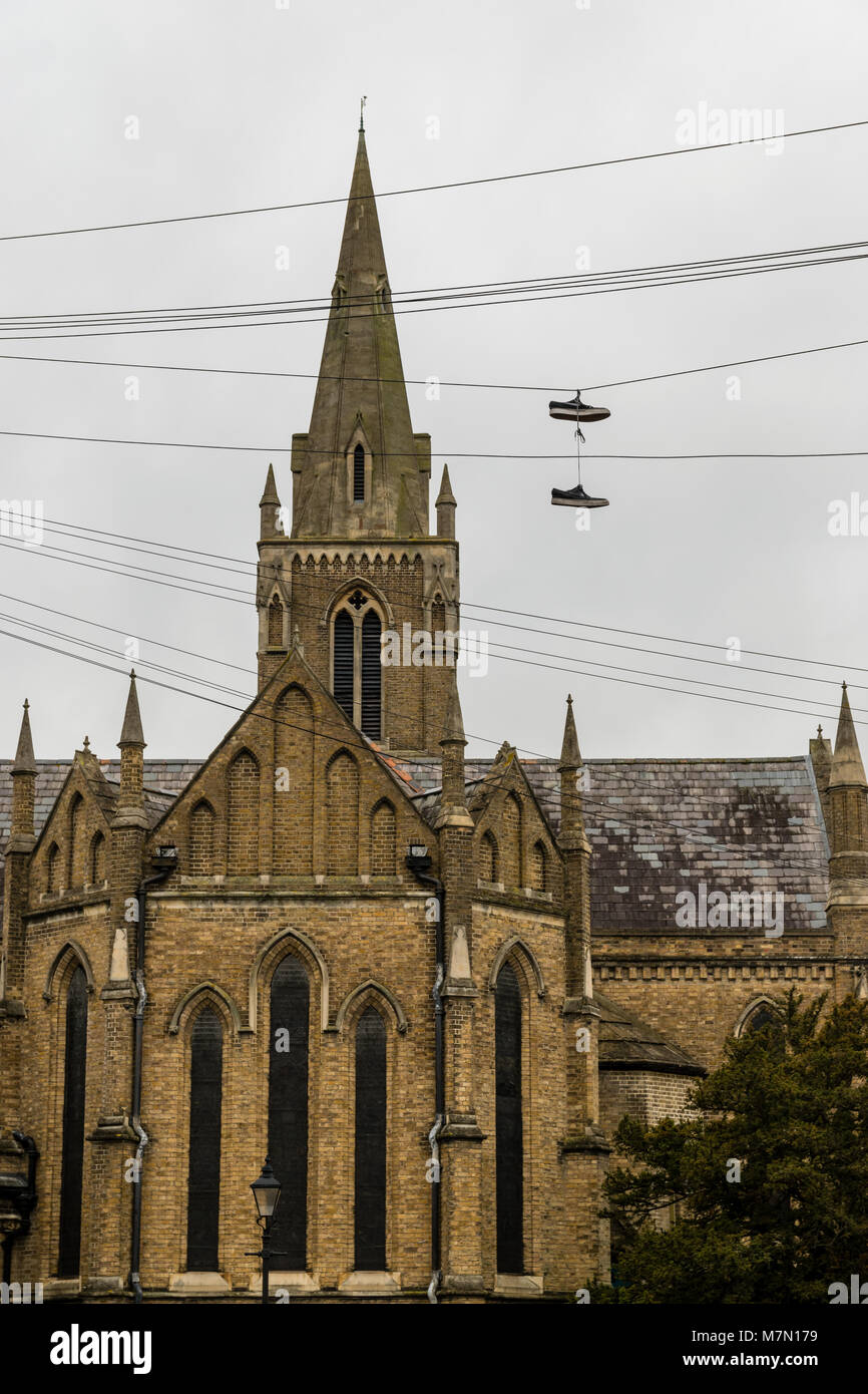 A pair of trainers dangling from telephone wires by Holy Trinity Church ...