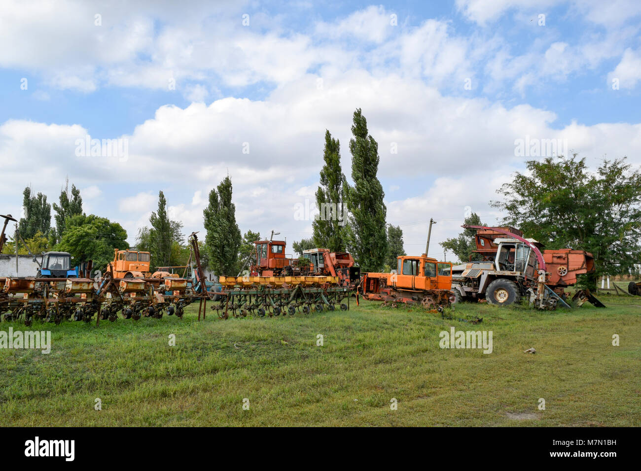 Open-air garage for agricultural machinery. Old tractors, combines and ...