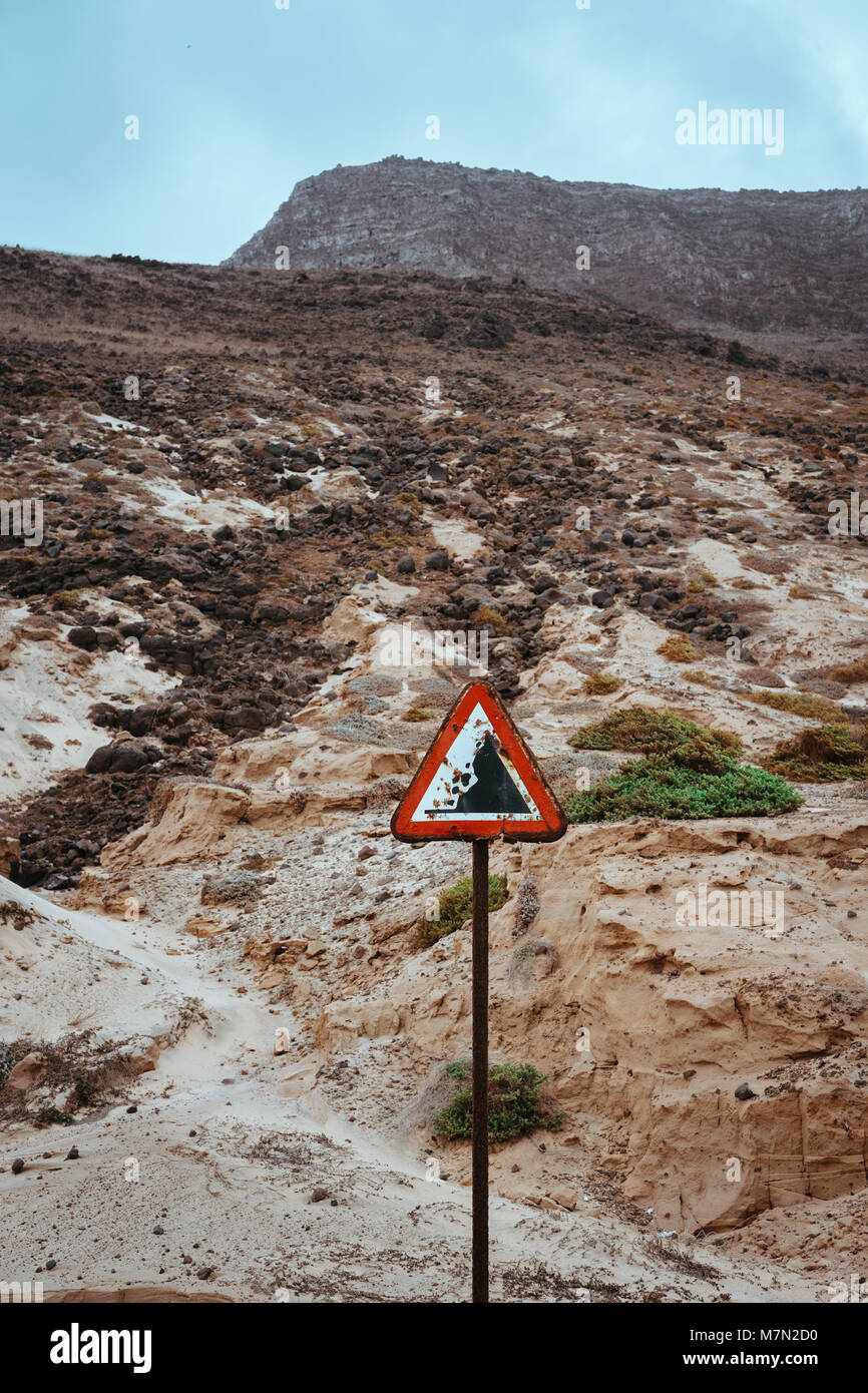 Warning road sign, beware of falling rocks Stock Photo - Alamy