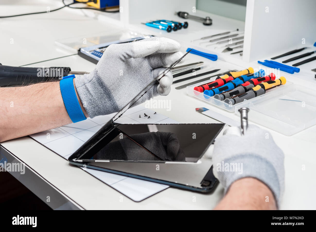 Close-up photos showing process of tablet device repair Stock Photo - Alamy