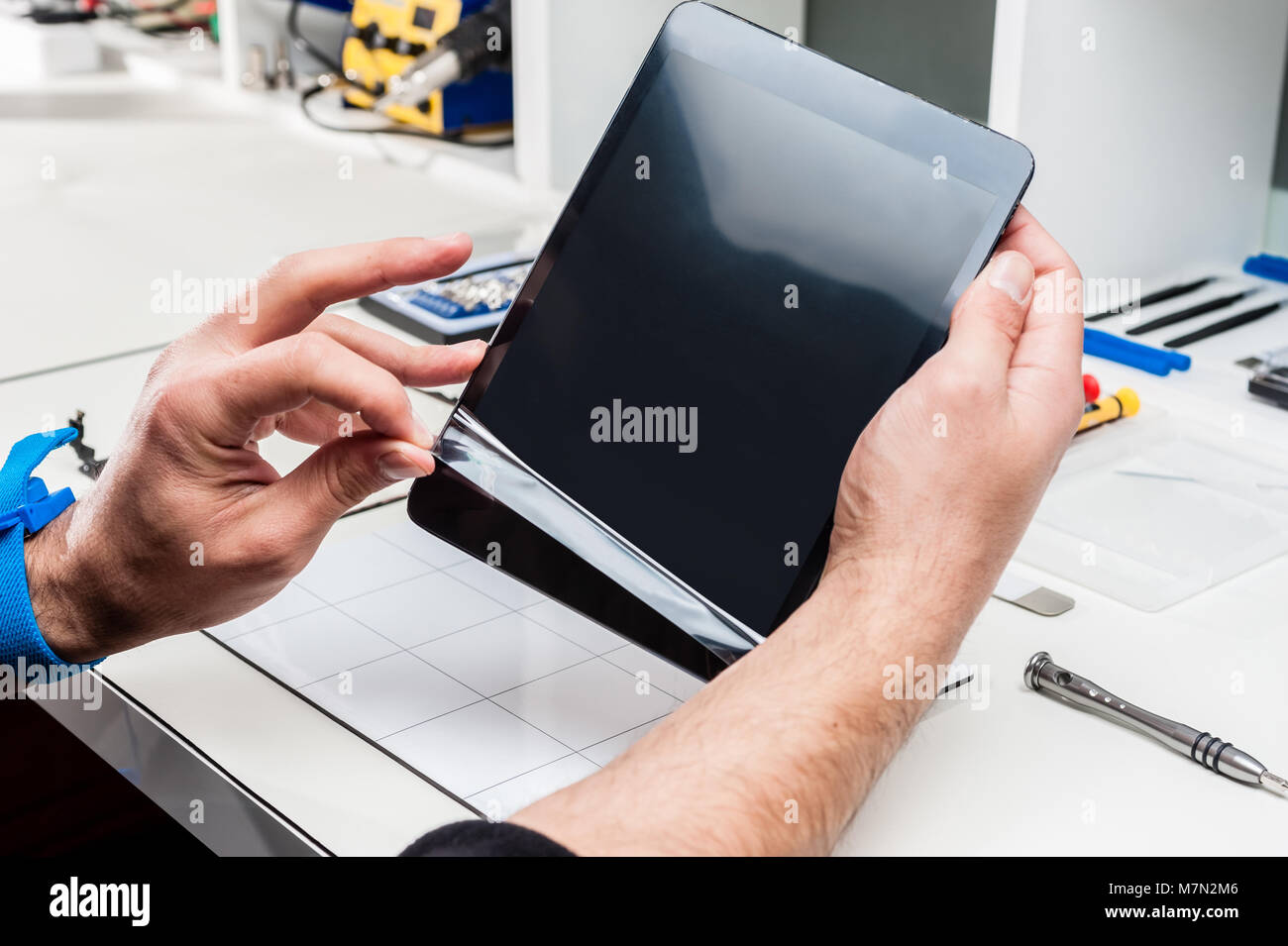 Close-up photos showing process of tablet device repair Stock Photo - Alamy