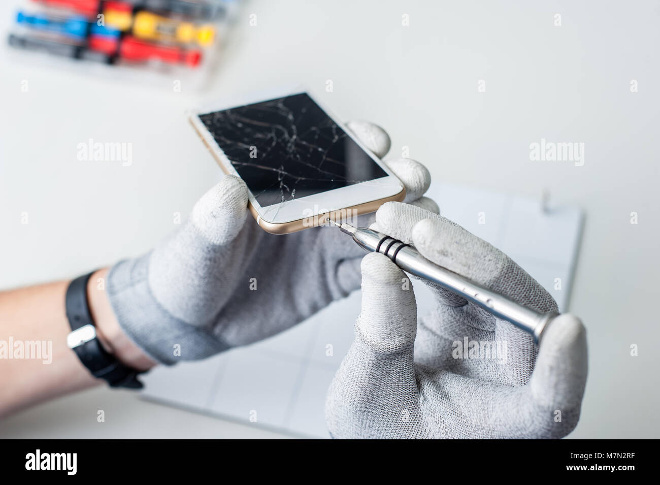 Close-up photos showing process of mobile phone repair, changing the ...