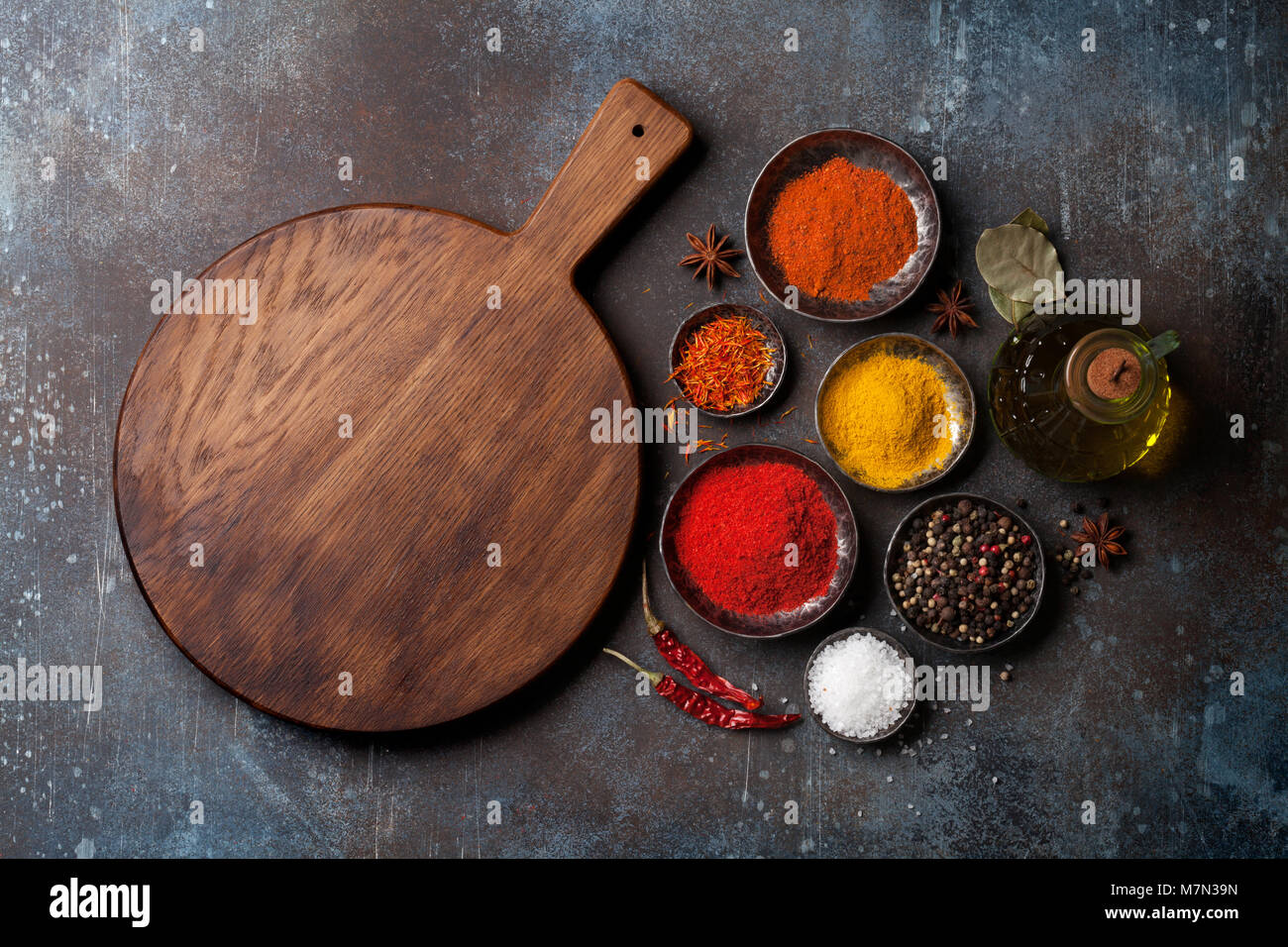 Colorful spices on stone table. Top view with space for your recipe ...
