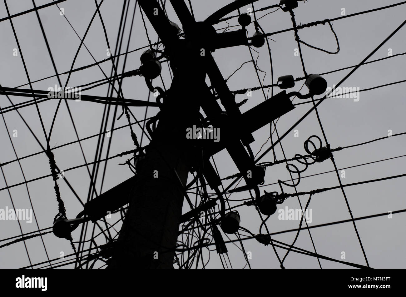 silhouette of messy electric wires on concrete pole. silhouette ...