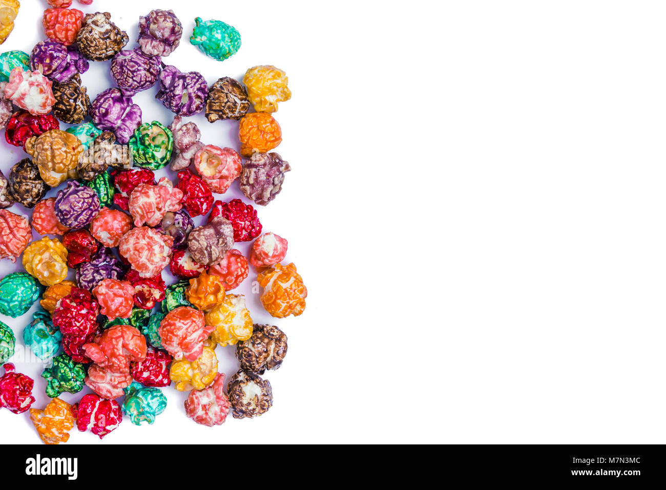 Brightly Colored Candied Popcorn, white background. Horizontal image of ...