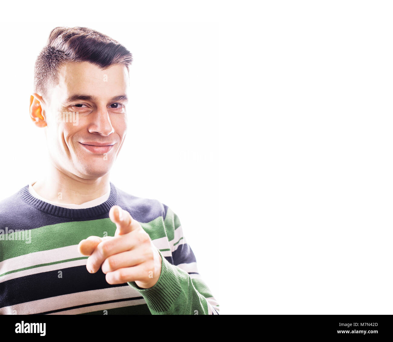 Portrait of a smart serious young man standing against white bac Stock ...