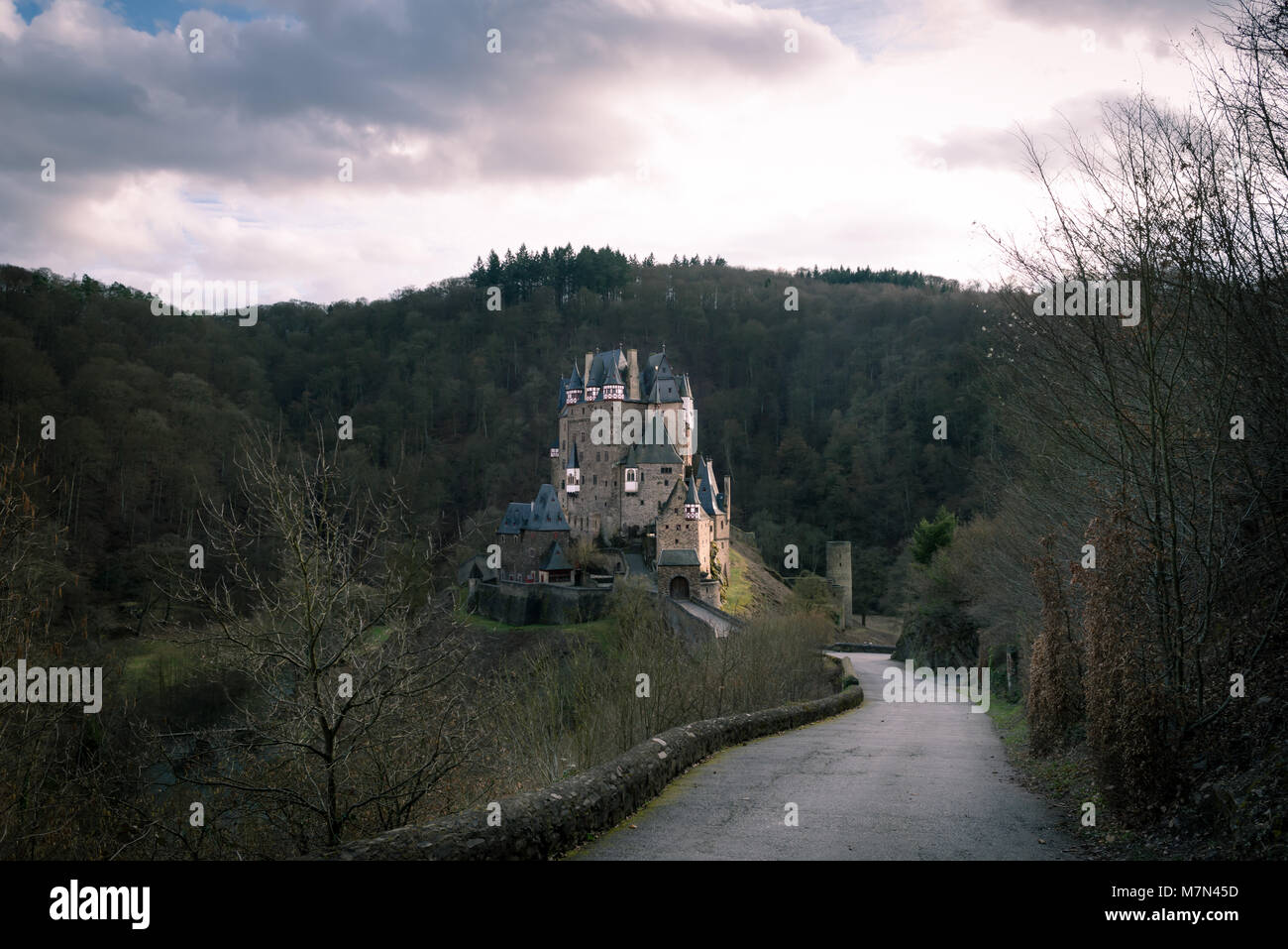 Long scenic road leading to a beautiful castle. Fabulous medieval place ...