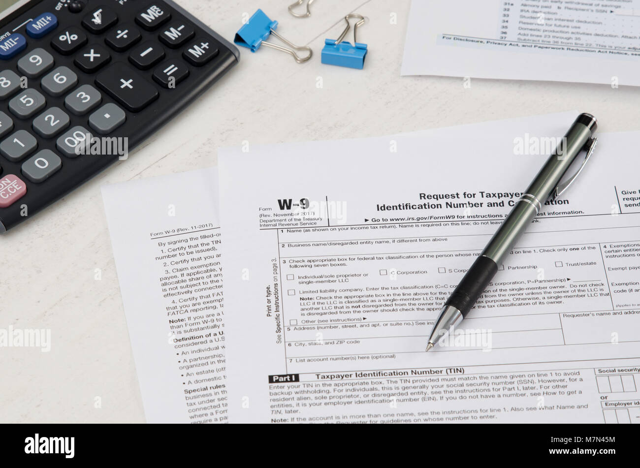 US tax form W-9 with pen and calculator. Tax form law document usa business concept Stock Photo ...