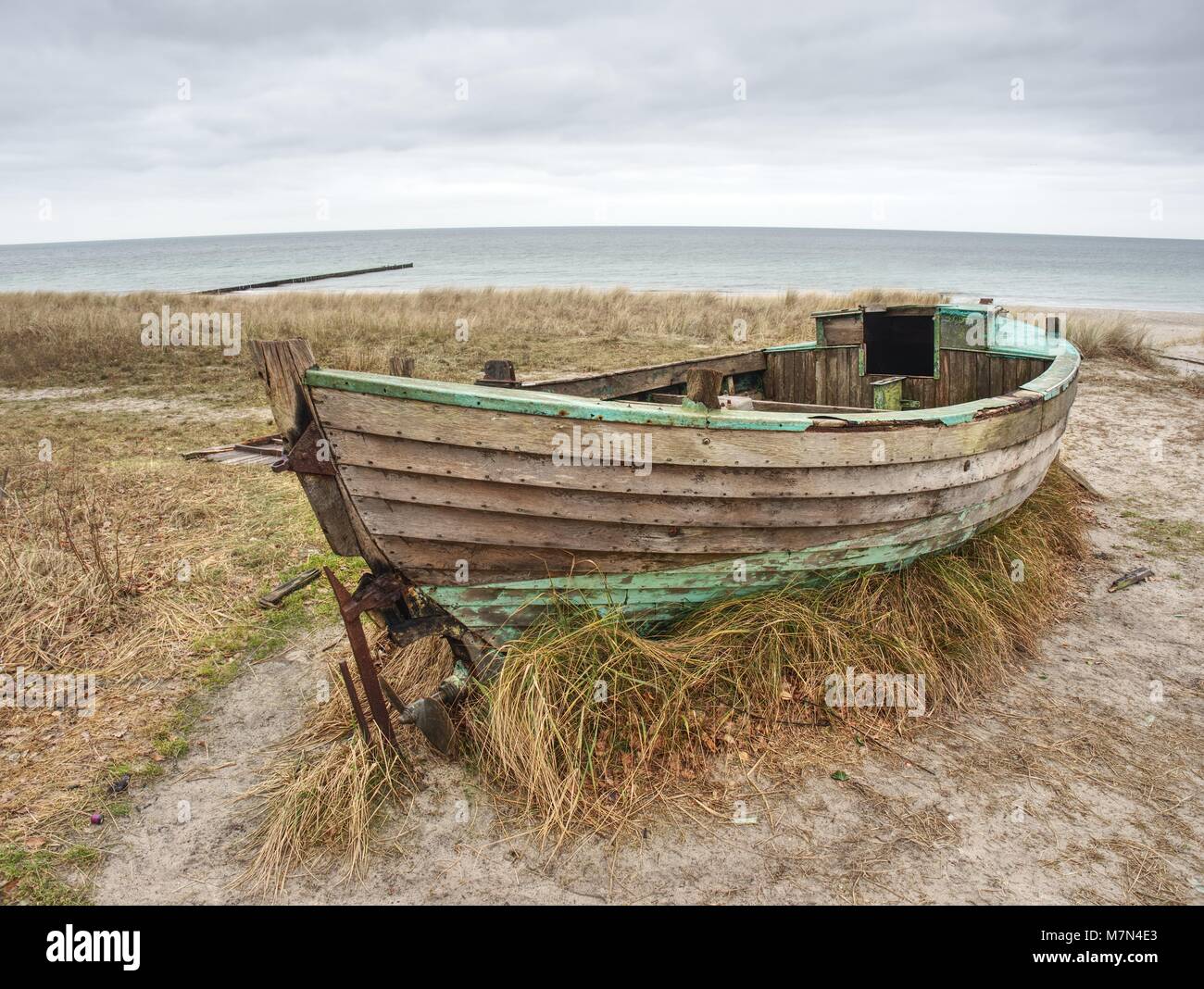 Abandoned wrecked boat stuck in sand. Old wooden boat on the sandy ...