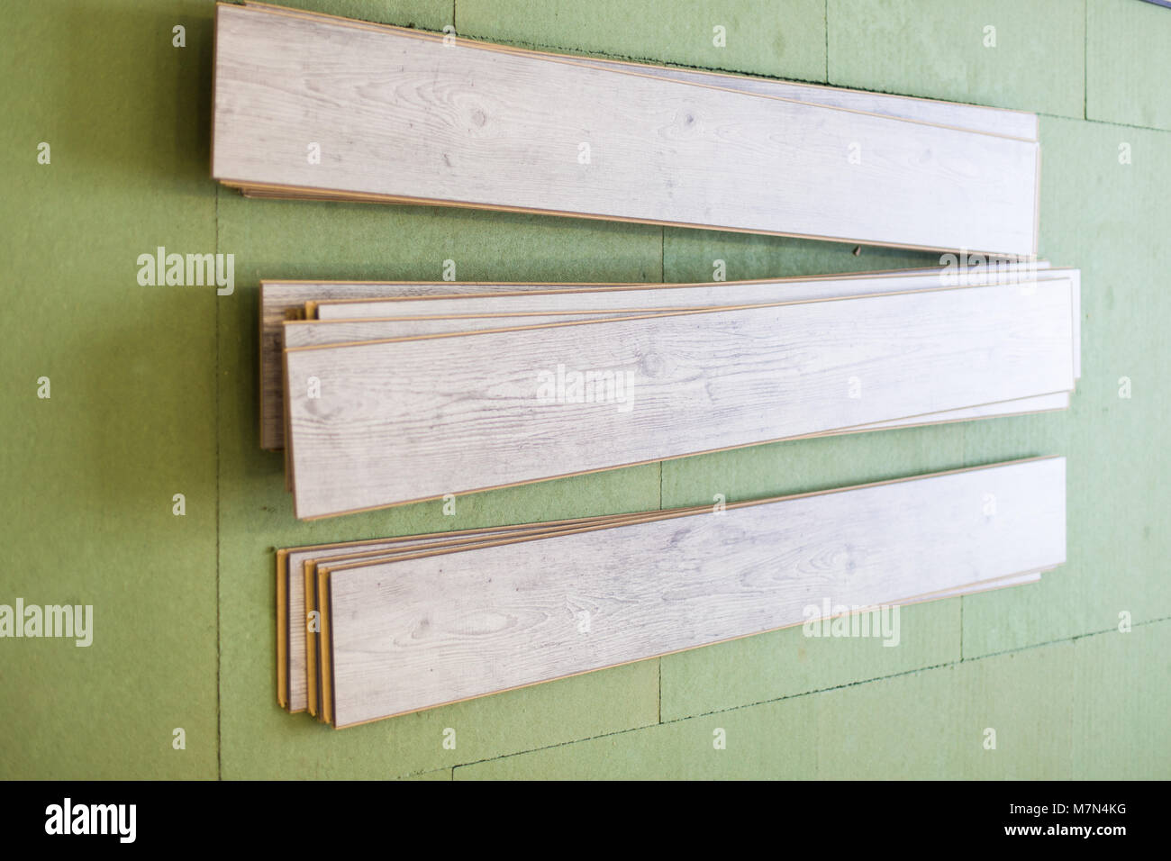 Wooden gray panels on new laminated flooring Stock Photo - Alamy