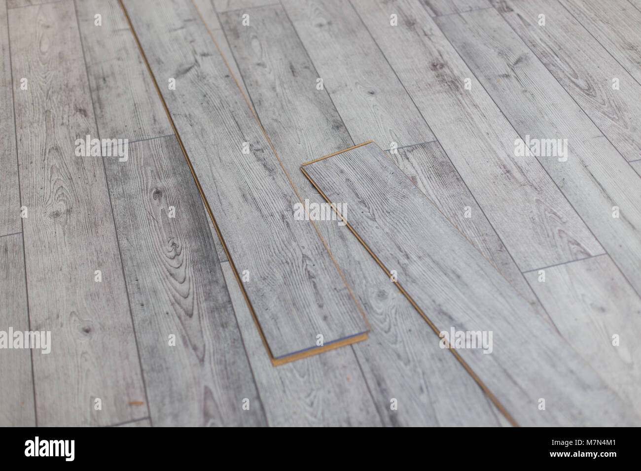 Wooden gray panels on new laminated flooring Stock Photo - Alamy