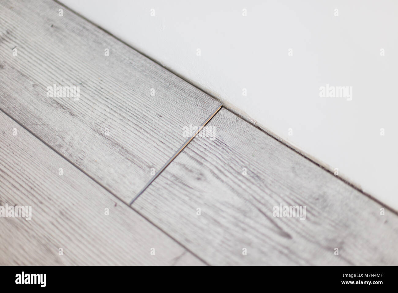 Wooden gray panels on new laminated flooring Stock Photo - Alamy